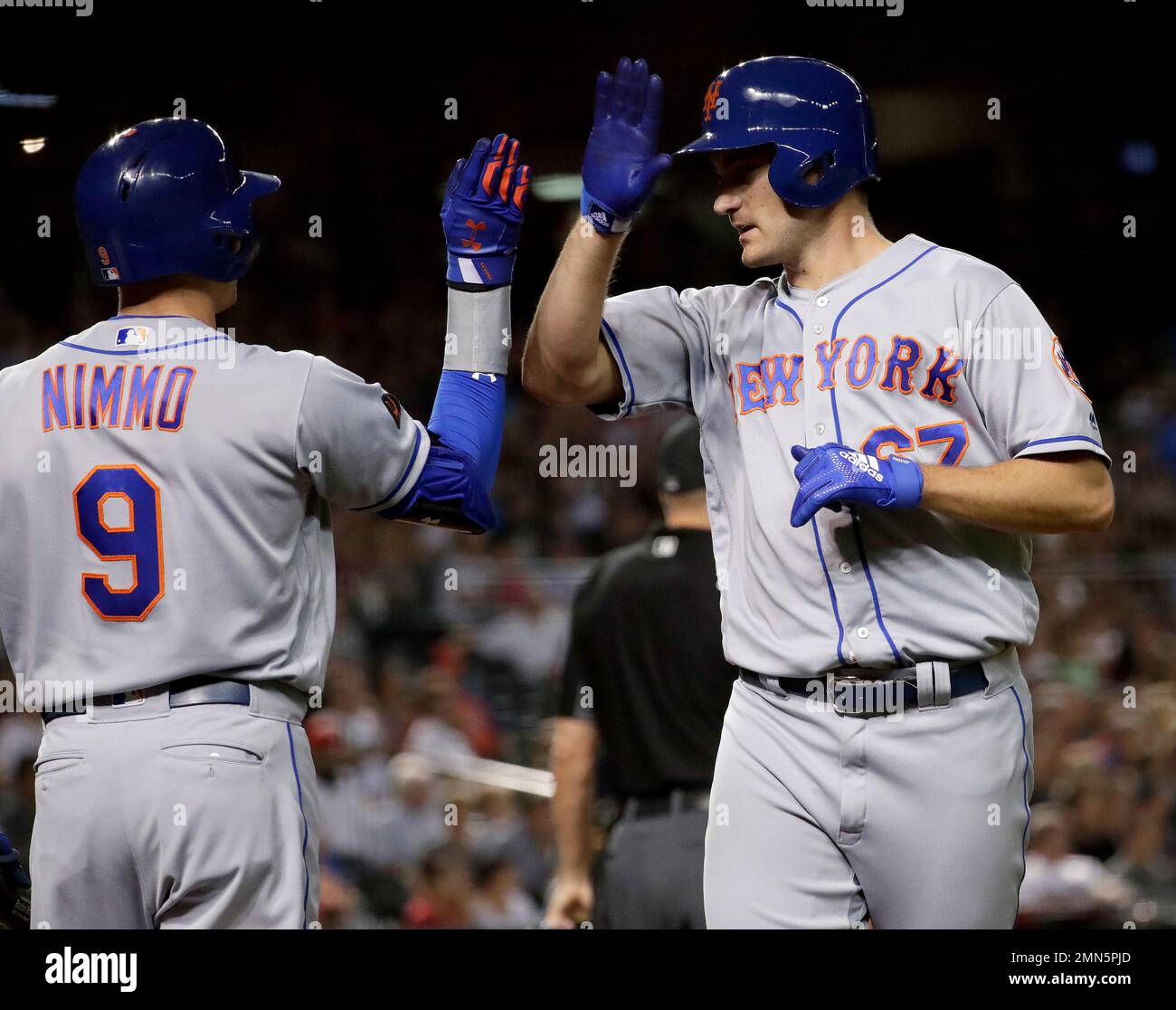 New York Mets' Seth Lugo high-fives Brandon Nimmo (9) after scoring on ...