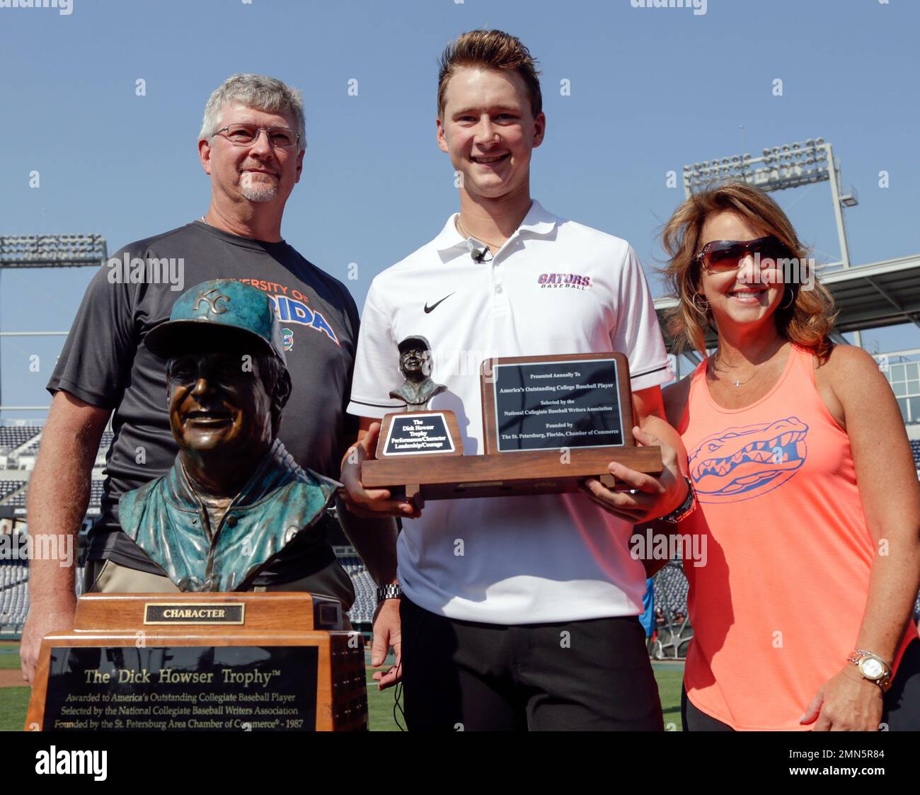 Florida pitcher Brady Singer poses with his parents, Brett and ...