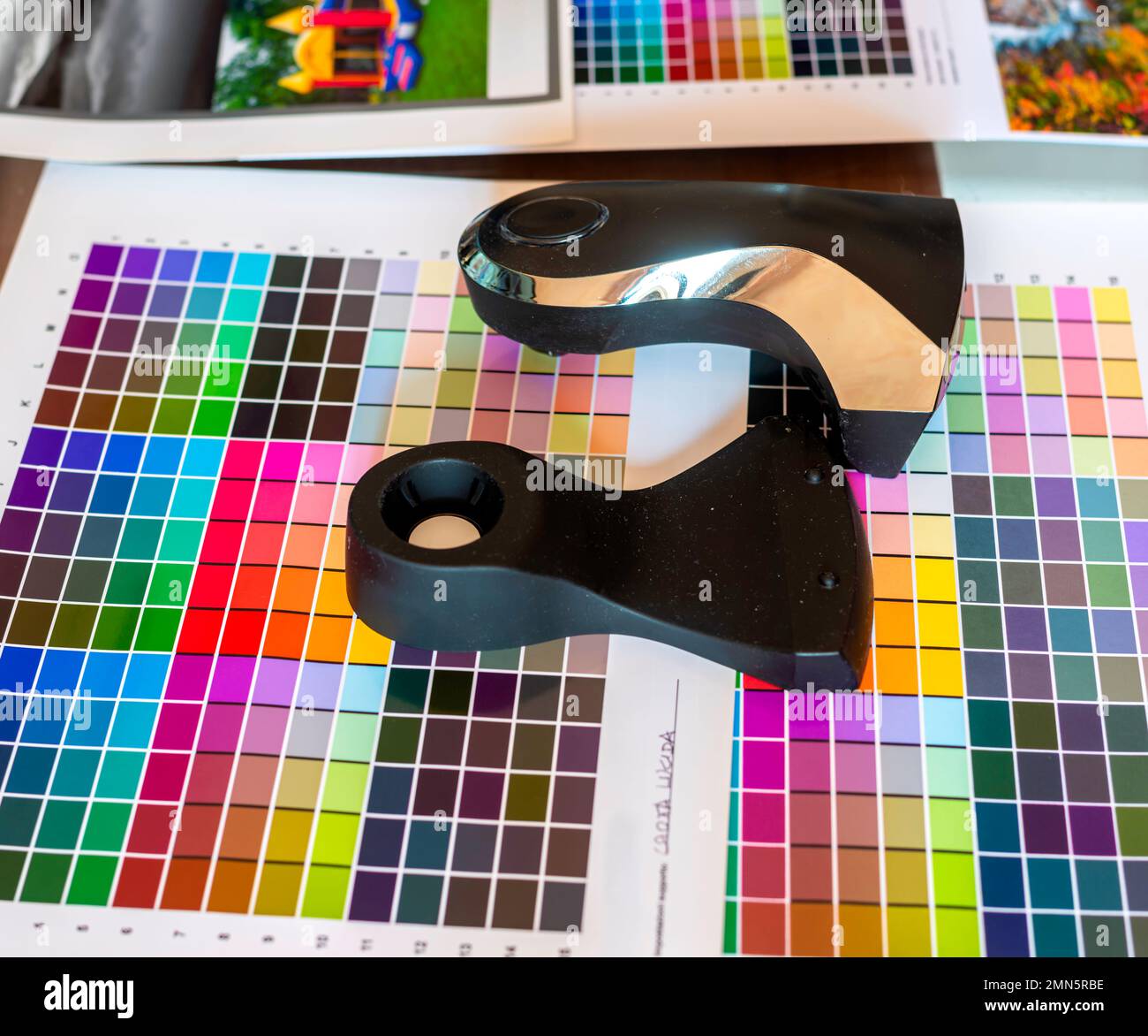 Technician uses a spectrocolorimeter to read patches with various ...