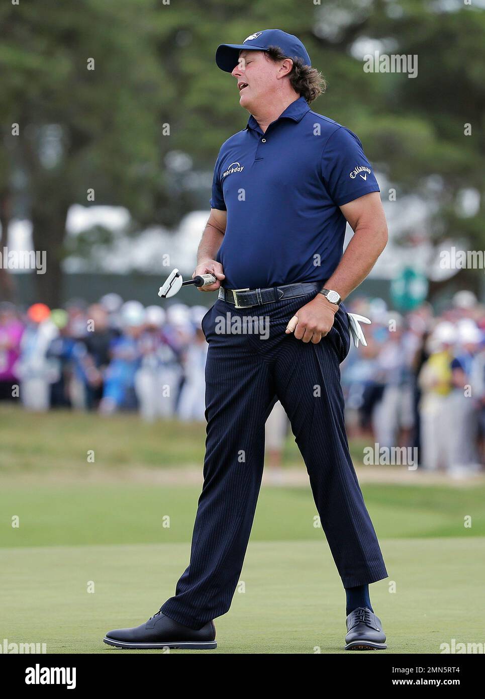 Phil Mickelson reacts after missing a putt on the fourth green during ...