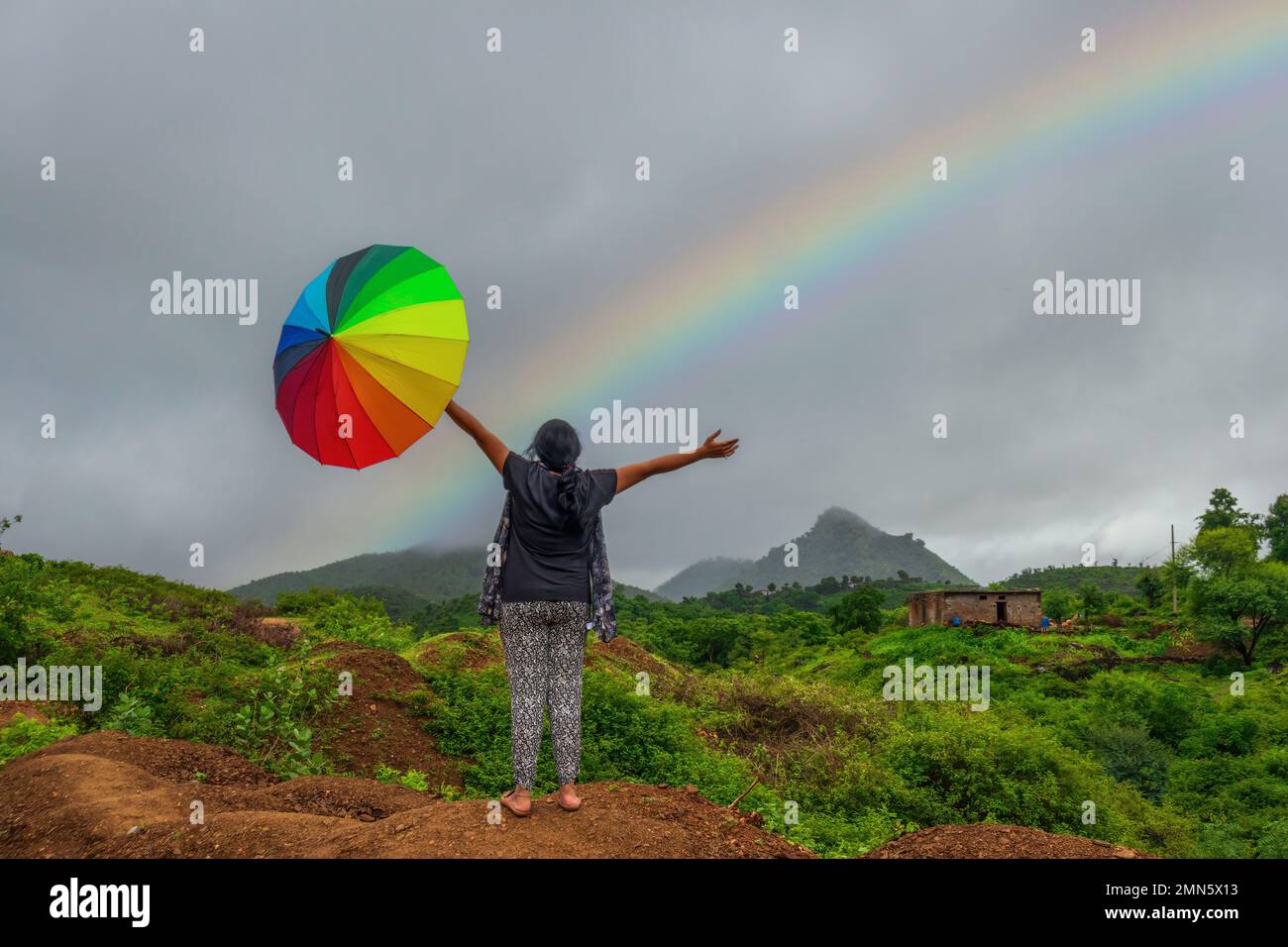 Woman holding colourful umbrella on a trek to Badi Lake in Udaipur ...