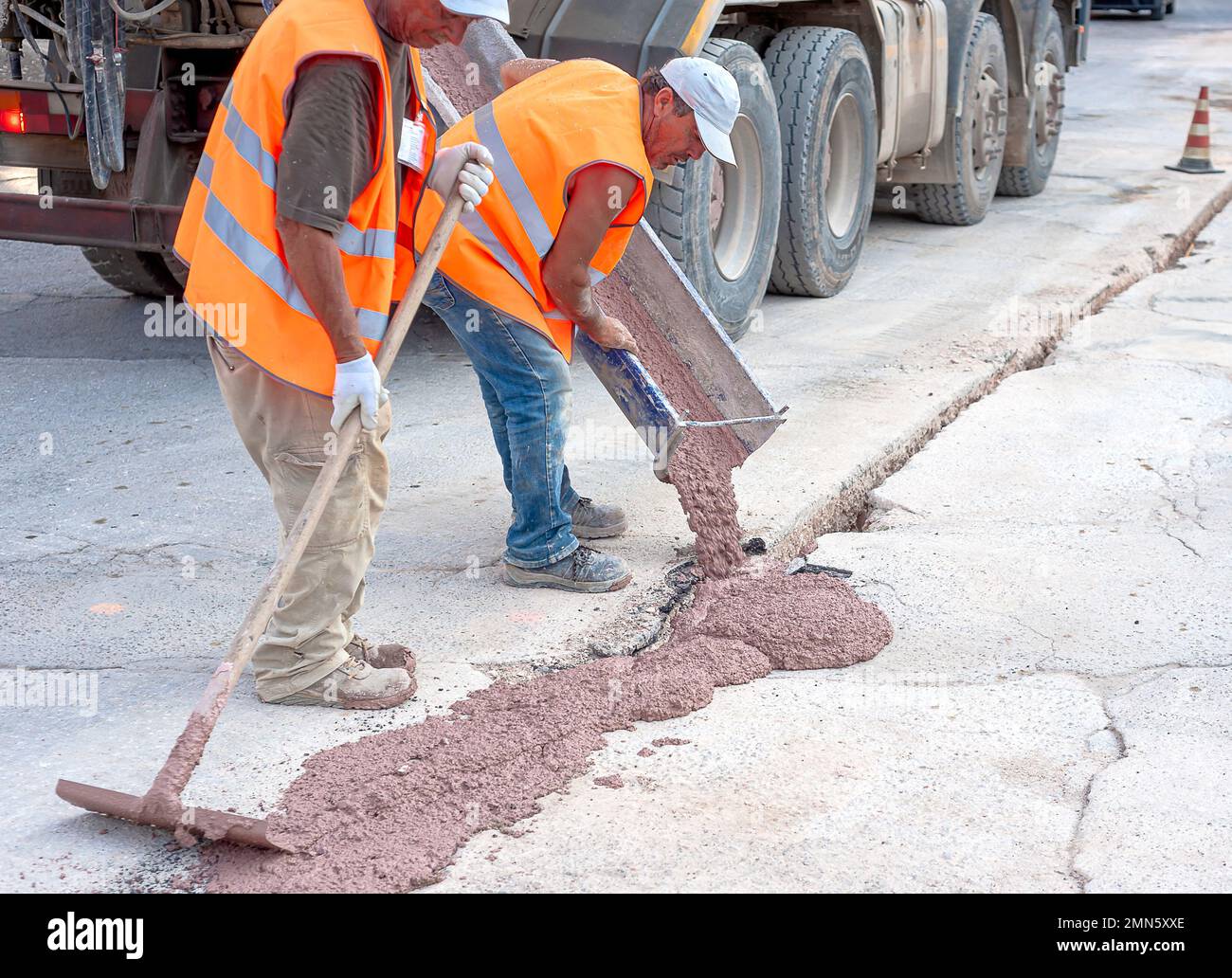 Filling with colored concrete of excavation with a narrow section for ...