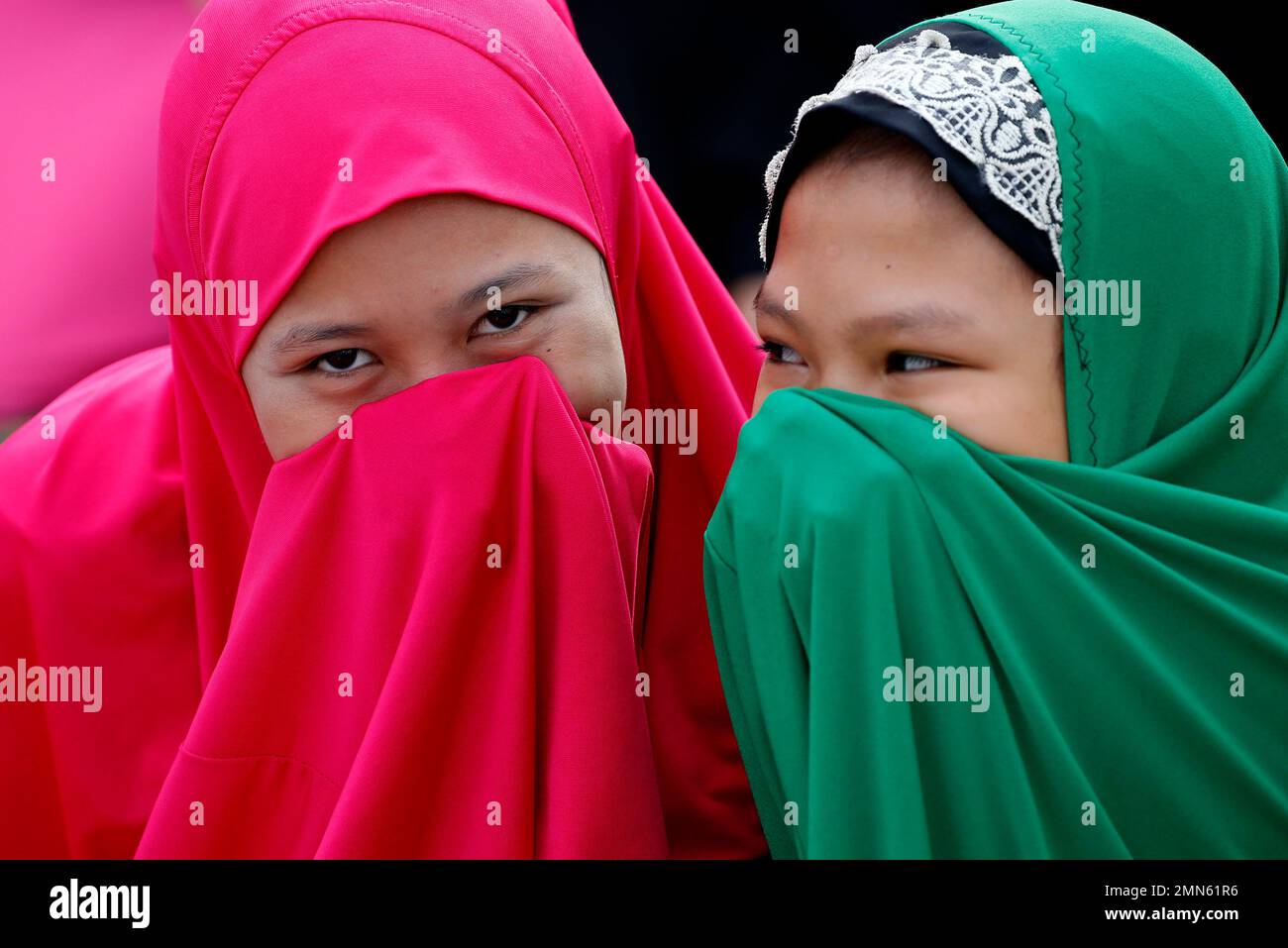 Filipino Muslims cover their faces as they gather outside the Blue ...