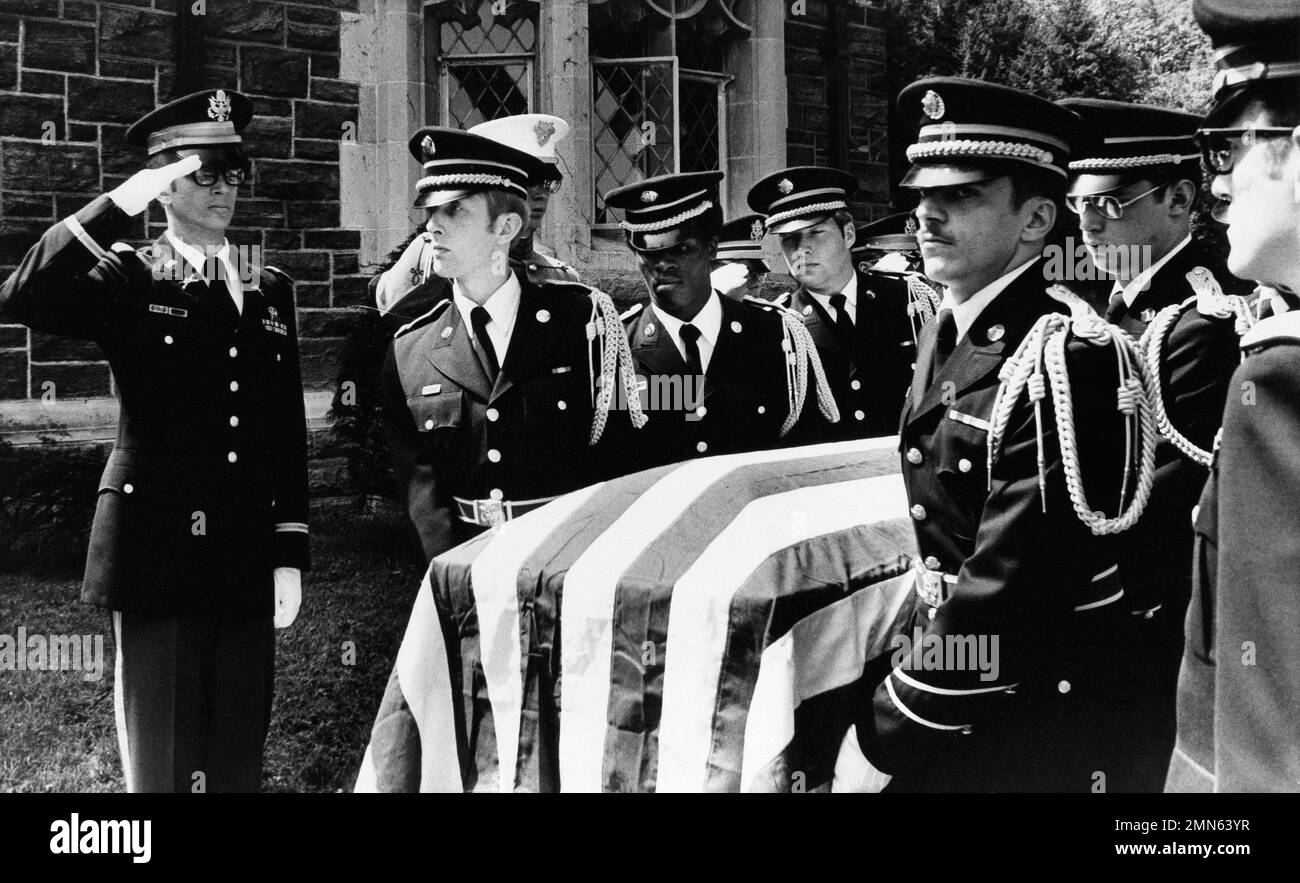 A mix of classmates and cadets acting as honorary pallbearers carry the ...