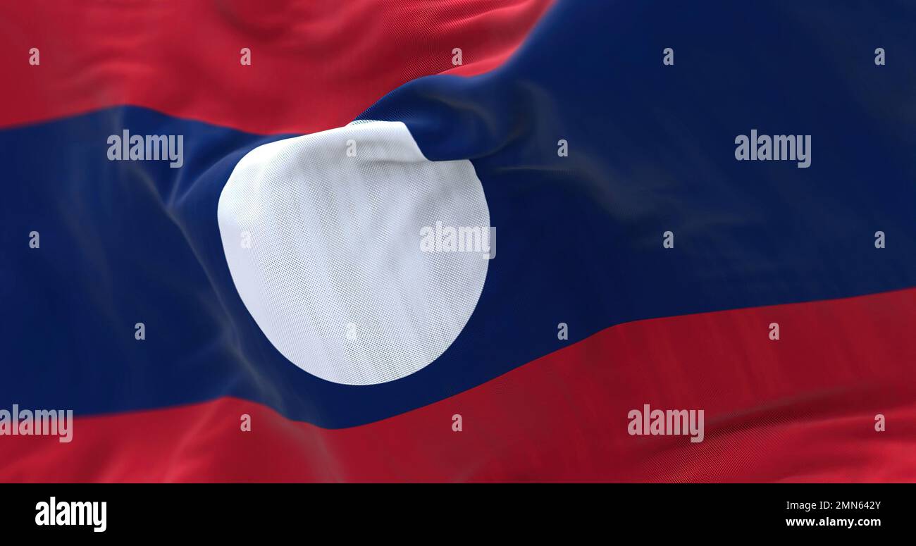 Detail of of the Laos national flag waving in the wind. The Lao People ...