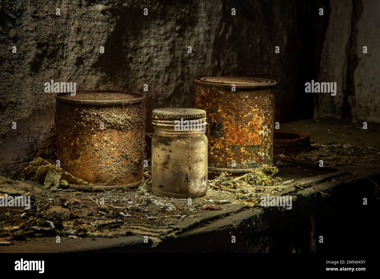 Rusty dirty cans and a dirty jar on a shelf in abandoned house ...