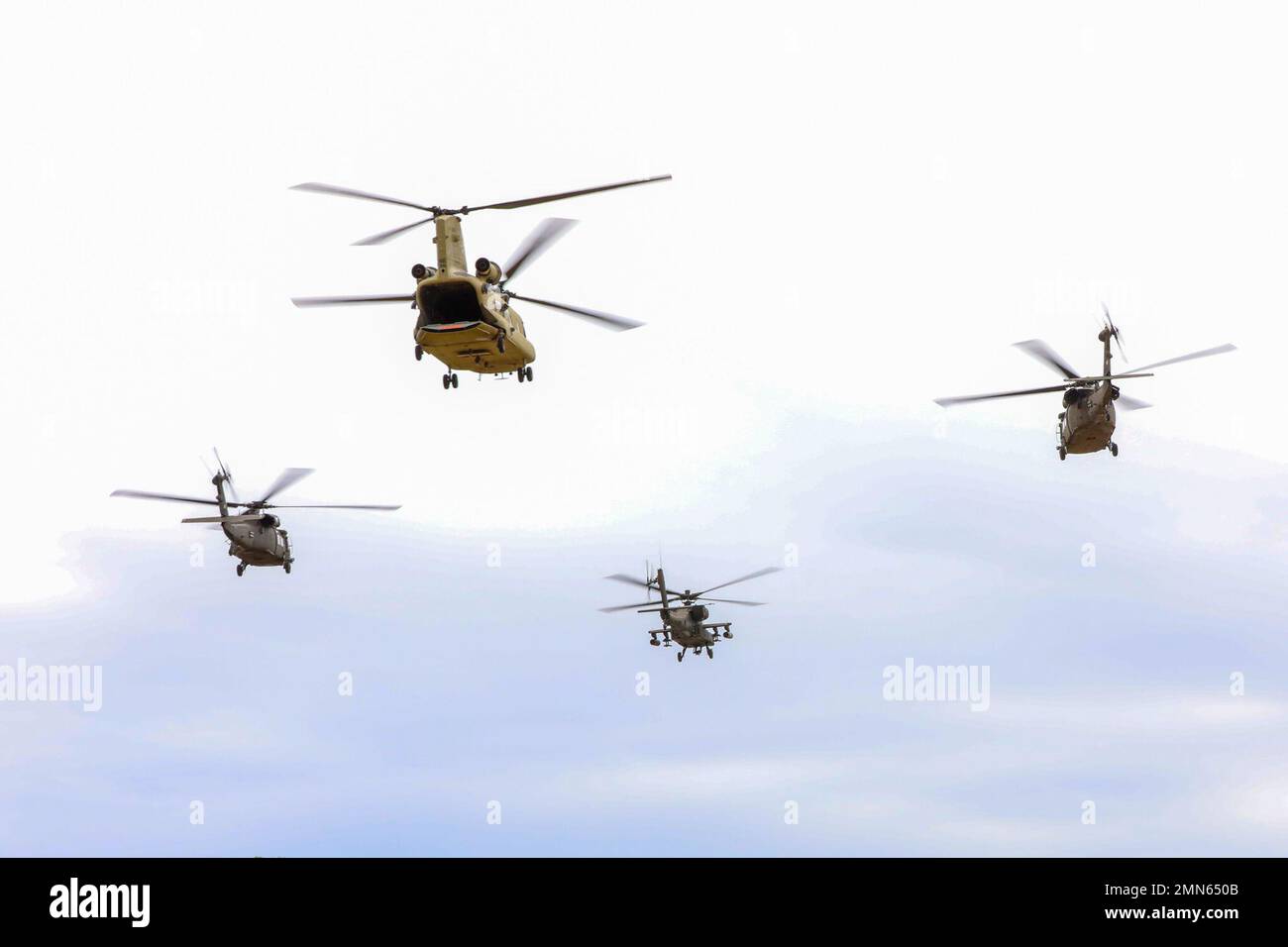 A formation of aircraft of the 82nd Airborne Division fly over a pass ...