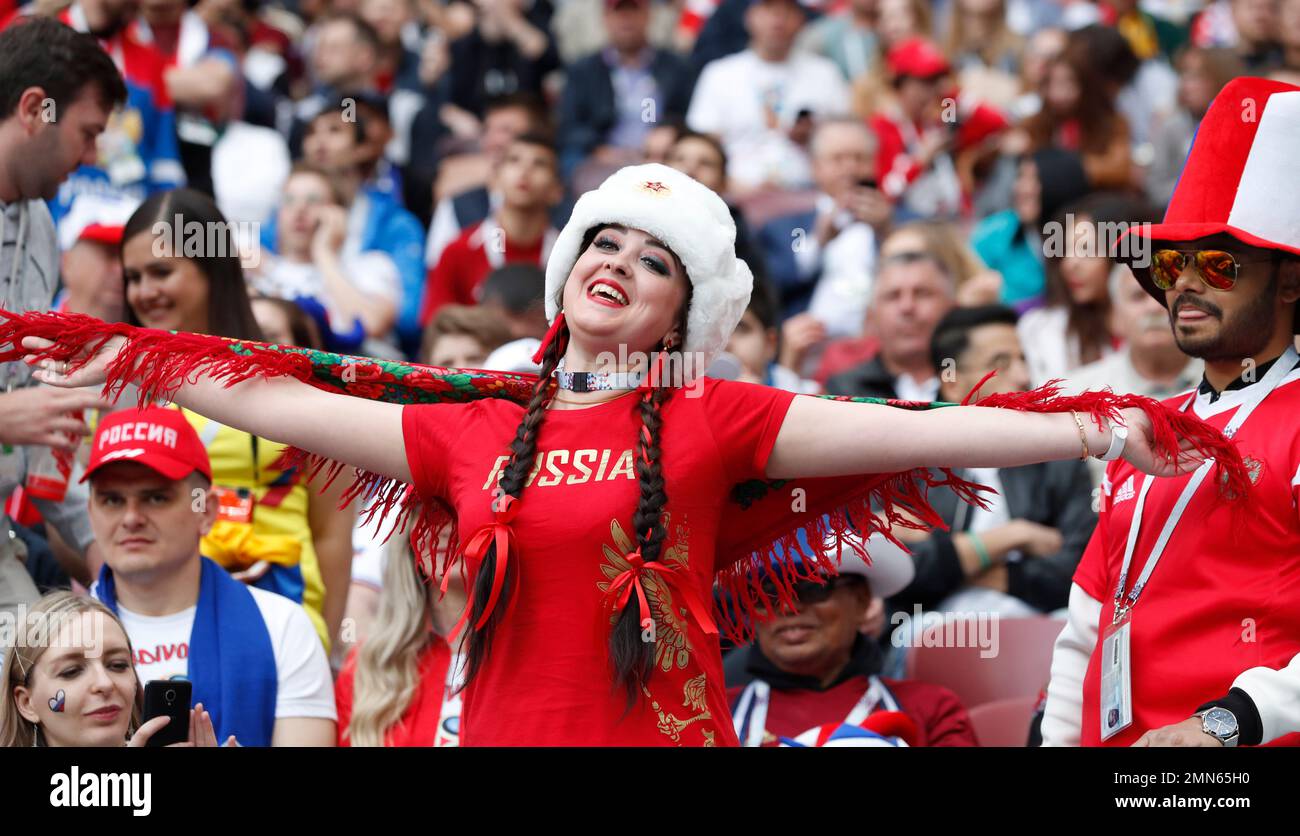 A Russian fan get ready to cheer on their side as they pose a ...