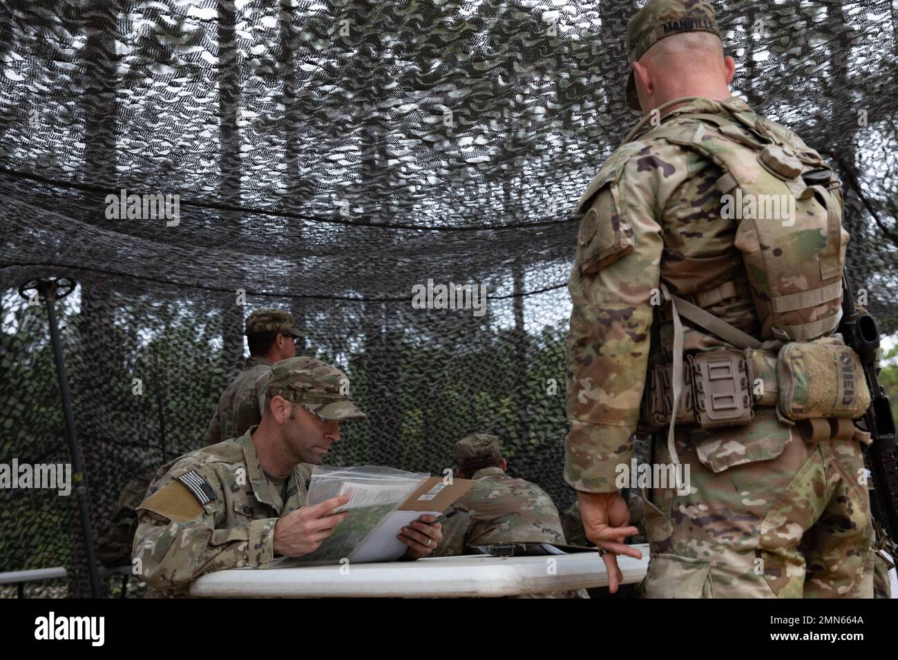 An U.S. Soldier waits while his coordinate points are confirmed during ...