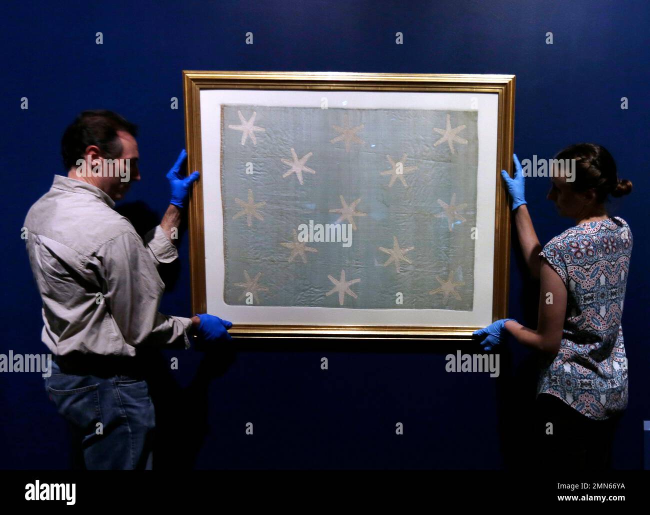 Collections manager Michelle Moskal, right, and curator Mark Turdo hang ...