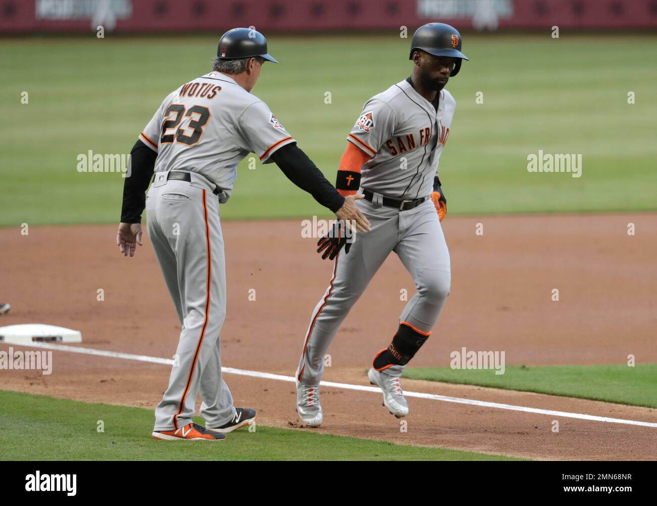 San Francisco Giants third base coach Ron Wotus (23) greets Andrew ...