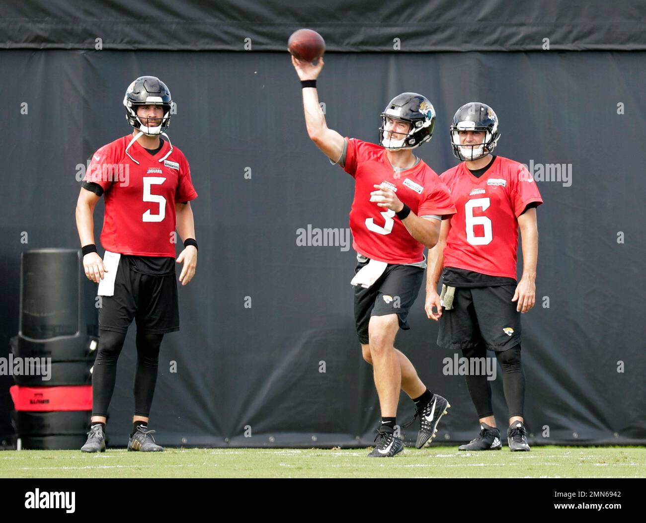 Jacksonville Jaguars quarterback Tanner Lee, center, throws a pass as ...