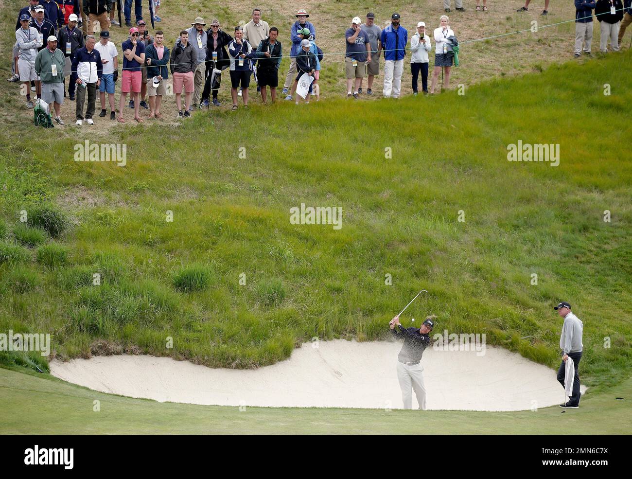 Phil Mickelson hits out of a bunker during a practice round for the U.S ...