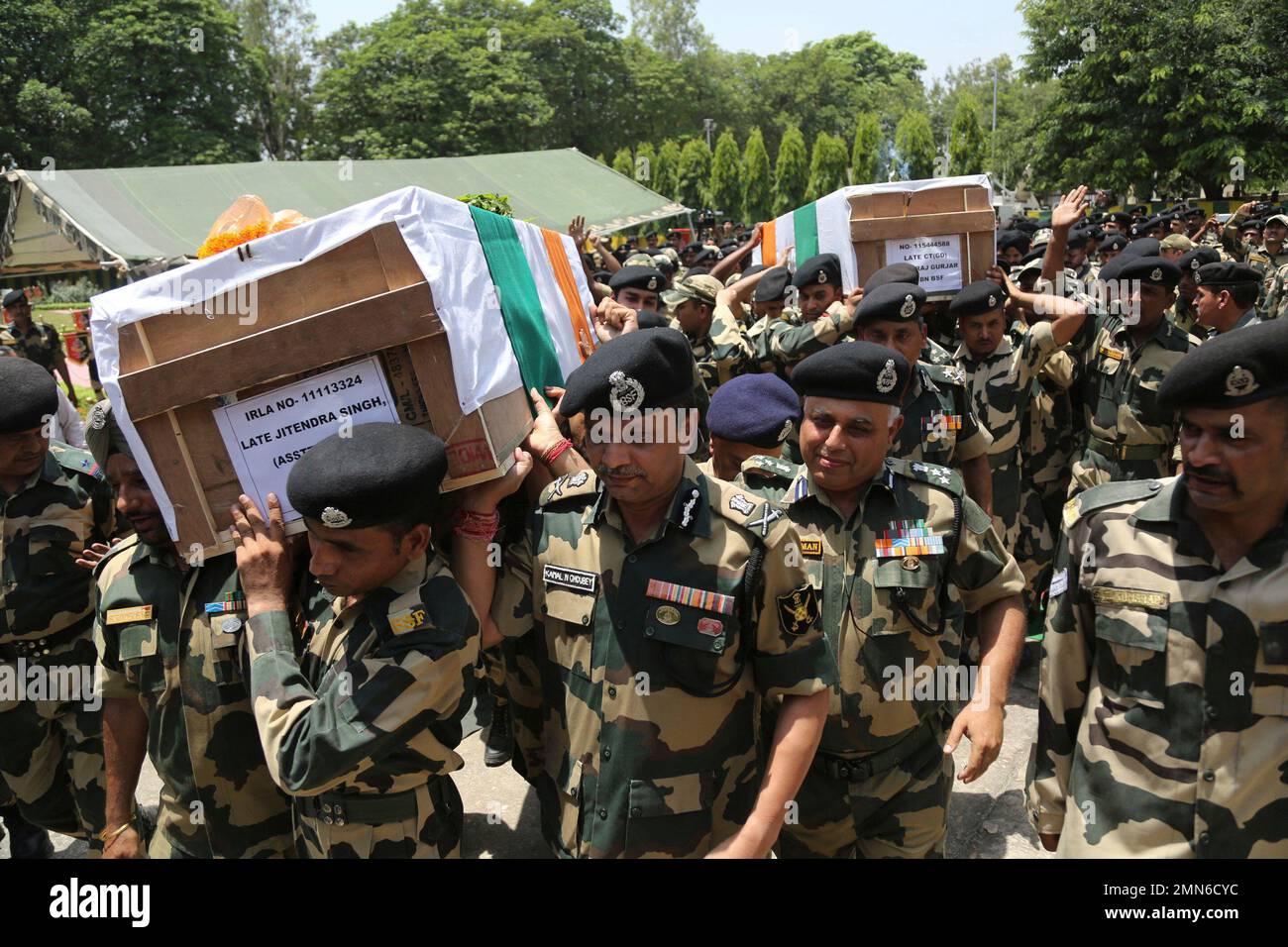 Indian Border Security Force (BSF) officers carry the coffins of four ...