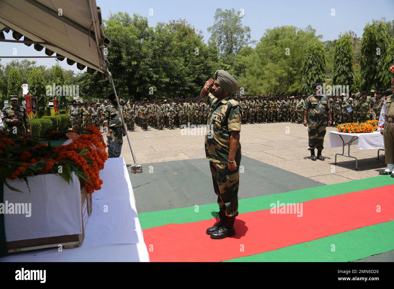 An Indian Border Security Force (BSF) soldier pays tribute to four of ...