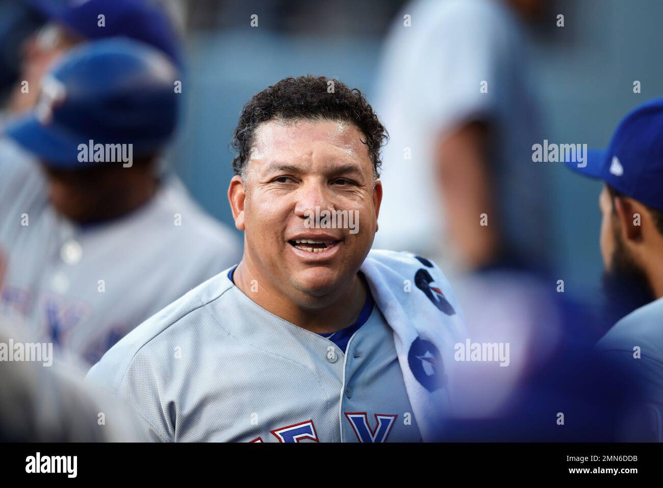 Texas Rangers starting pitcher Bartolo Colon smiles in the dugout ...