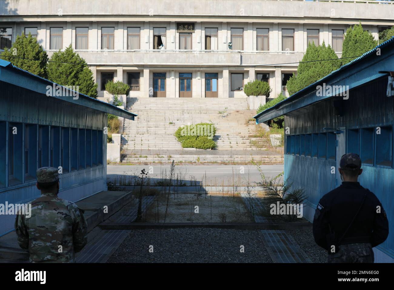 A U.S. Army soldier and R.O.K. soldier stand guard at the demarcation ...