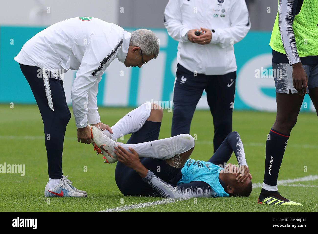 France's Kylian Mbappe grimaces after being injured during a training ...