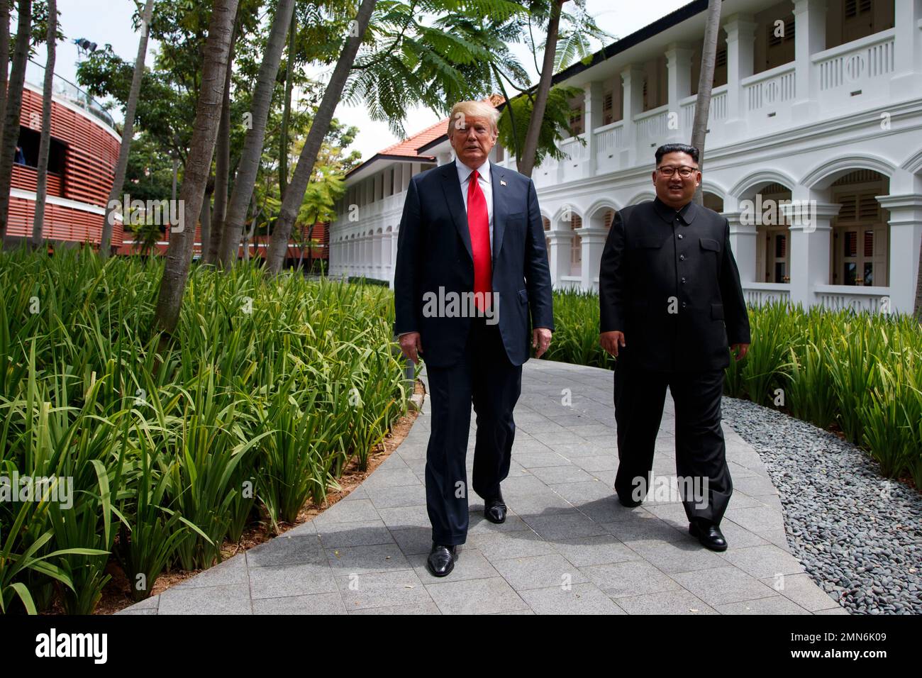 President Donald Trump walks with North Korean leader Kim Jong Un on ...