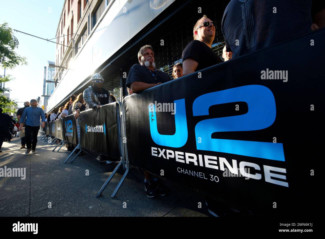 Fans line up outside the U2 concert hosted by SiriusXM at the Apollo ...