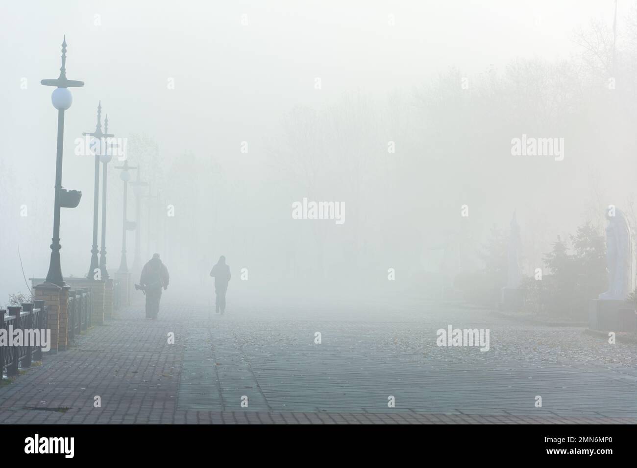 Unidentifiable figures of people in heavy fog Stock Photo - Alamy