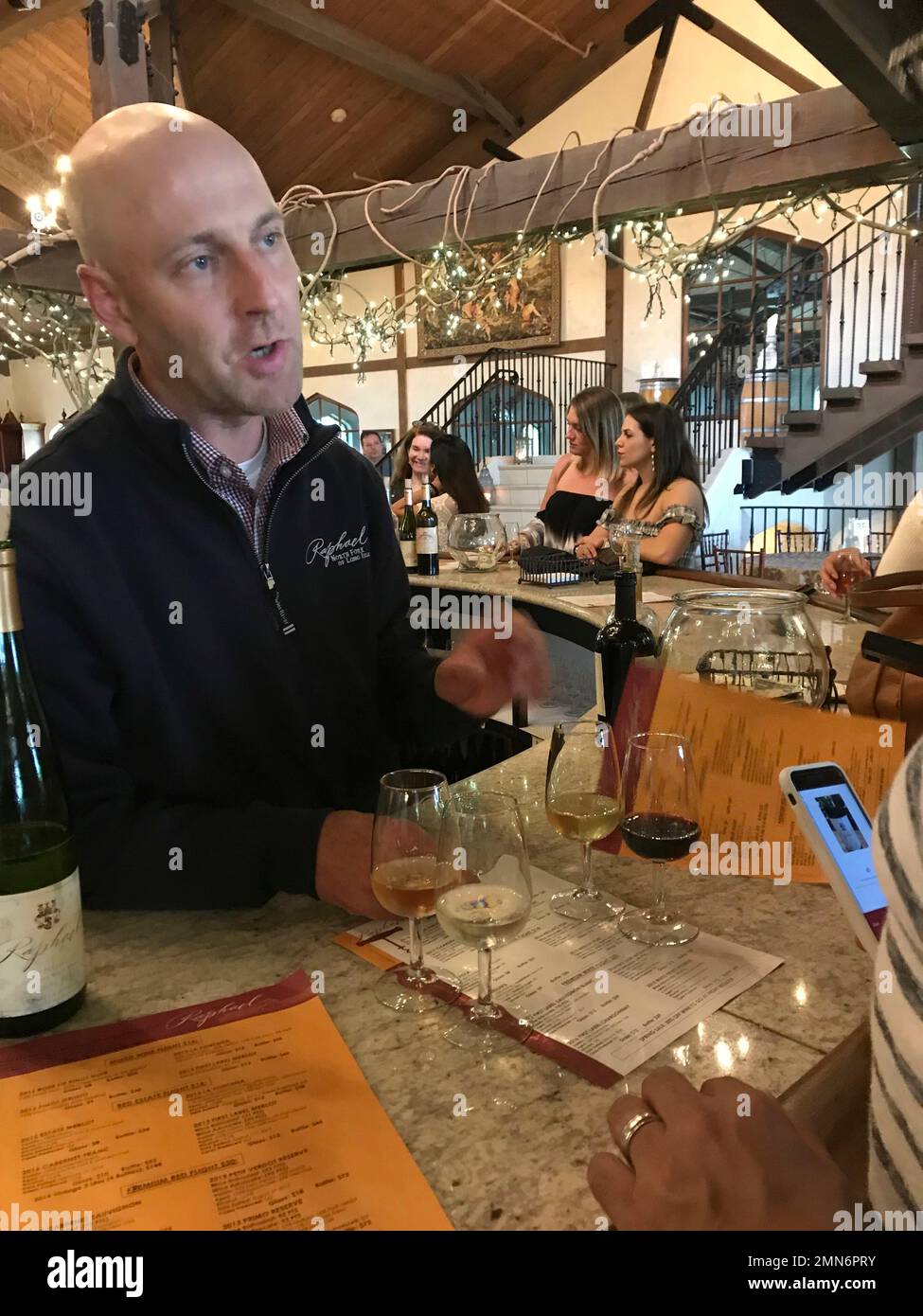 This May 19, 2018 photo shows a server describing the wines in a ...