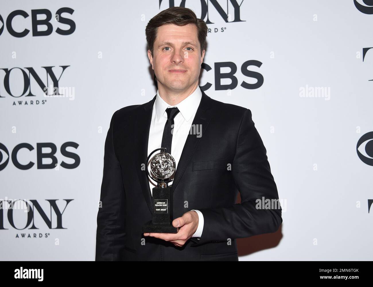 Neil Austin poses in the press room with the award for best lighting ...