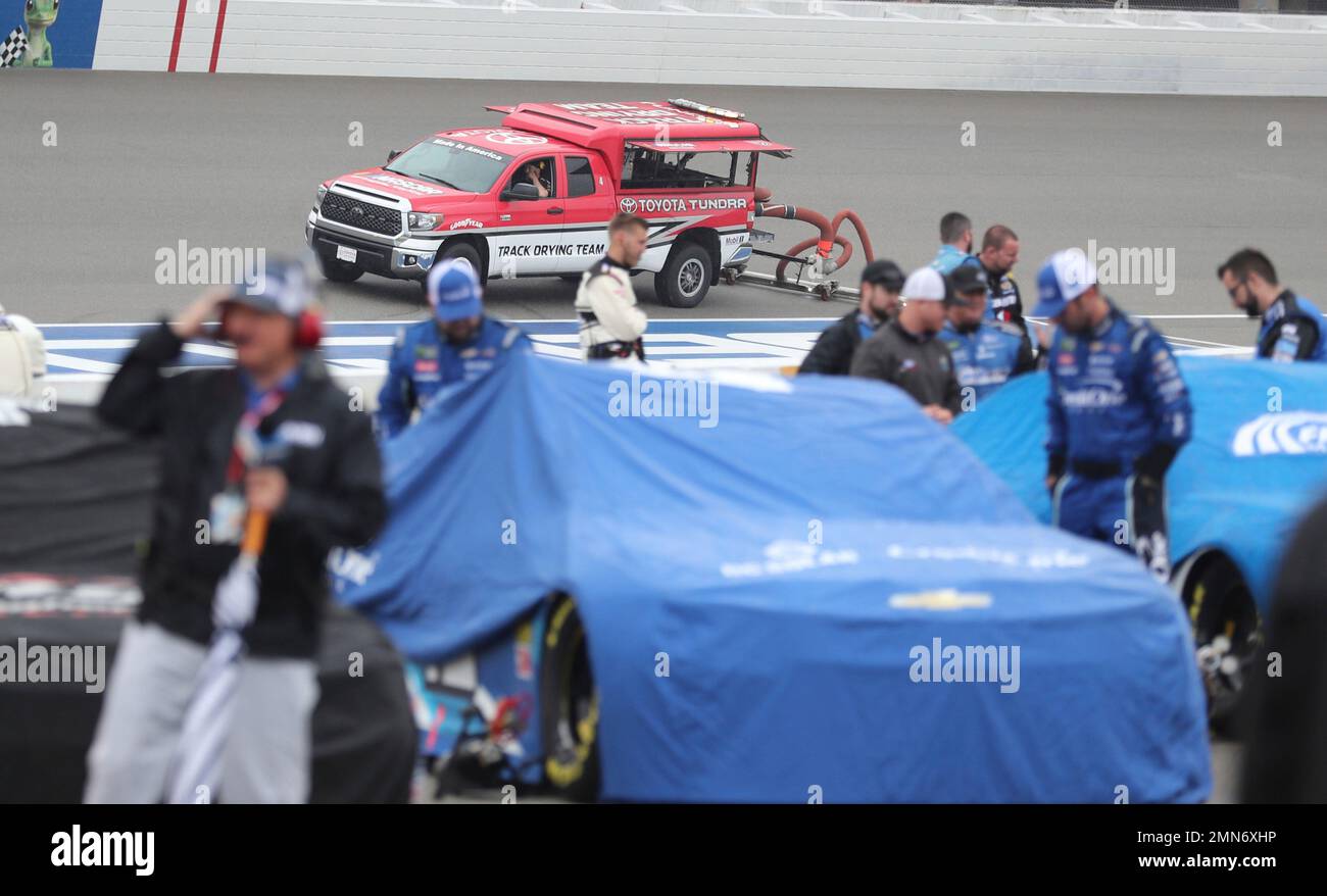 Air Titan track drying trucks drive on the track during a rain delay ...