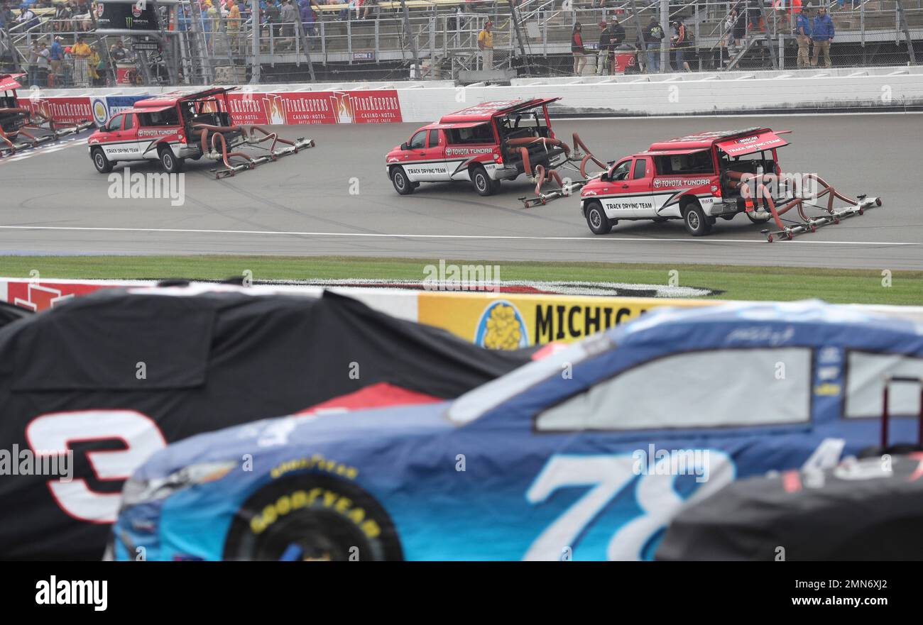 Air Titan track drying trucks drive on the track during a rain delay ...