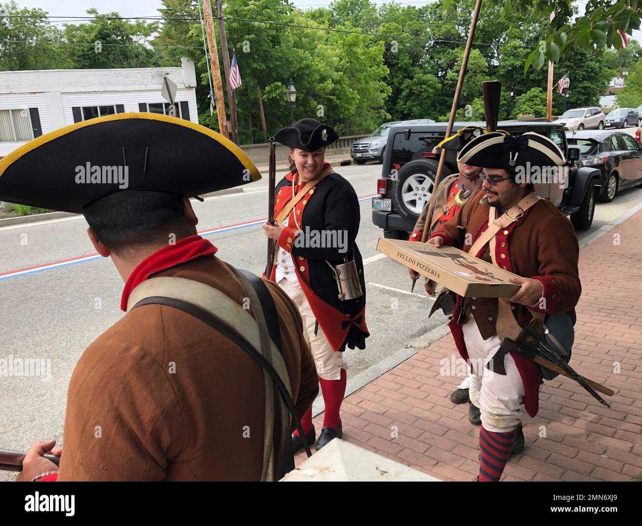 A group of volunteers re-enacting American colonists in the ...