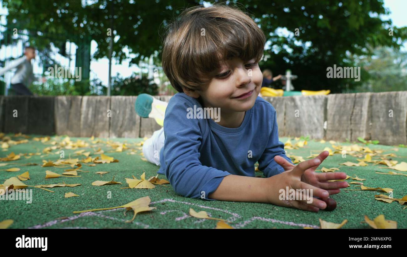 Child laying on ground hi-res stock photography and images - Alamy