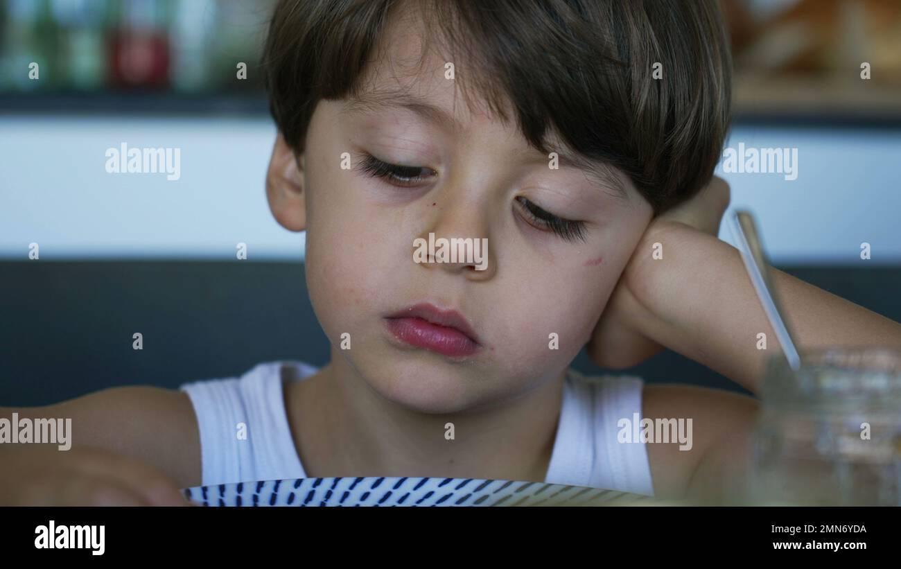 Portrait of a pensive child lost in thought. One contemplative little ...