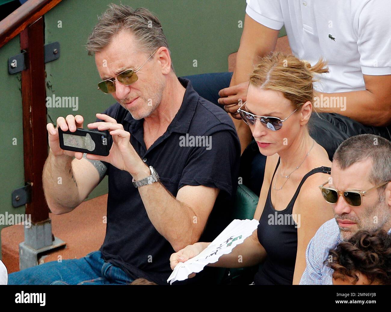 British actor Tim Roth and his wife Nikki Butler watch the men's final ...