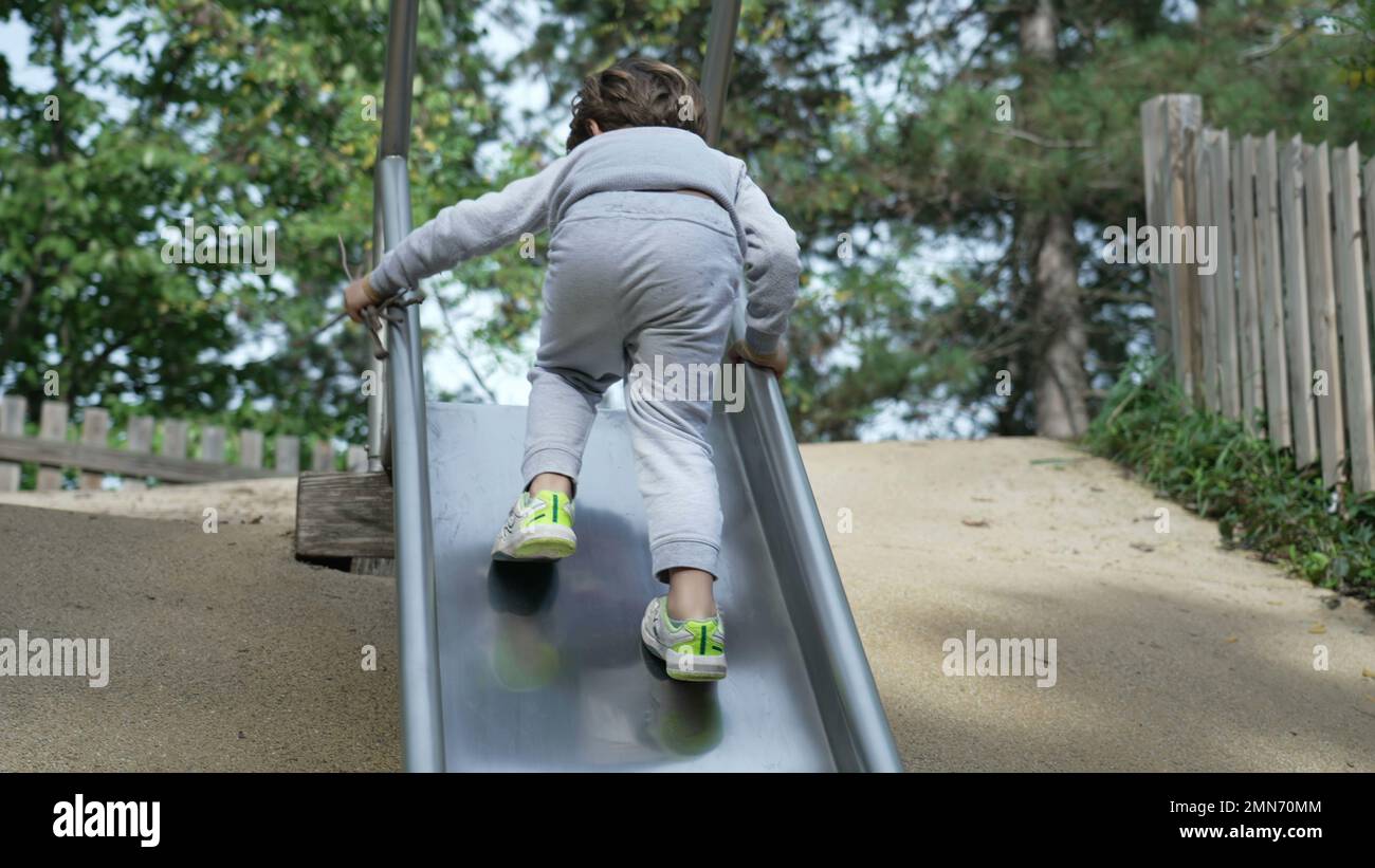 Child going down playground slide hi-res stock photography and images ...