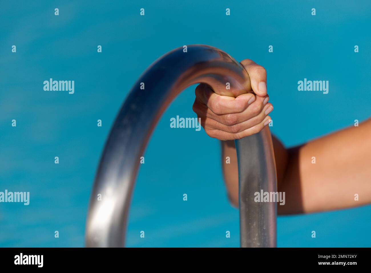 A woman hand holding a handrail in swimming pool Stock Photo - Alamy