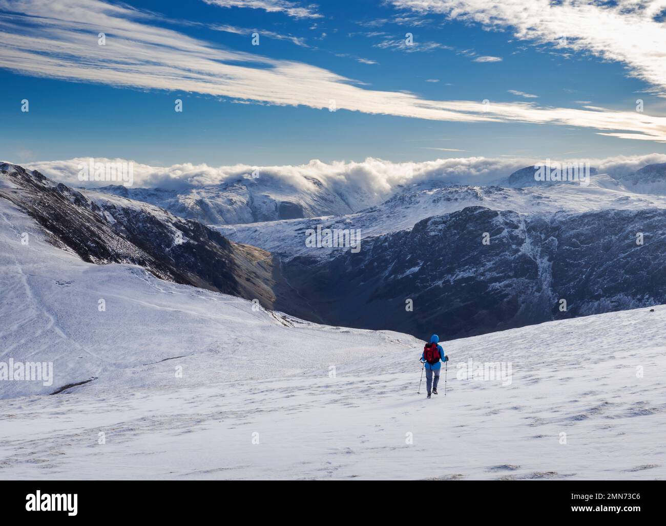 Cloud spilling over Glaramara with a woman hiker descending Robinson in ...