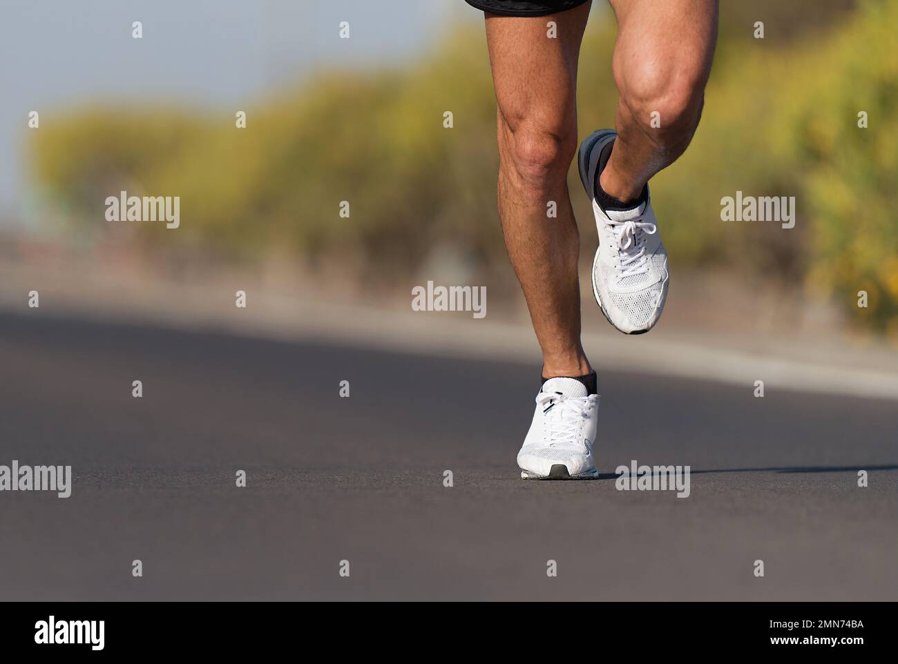Sport and fitness runner man running on road training for marathon run ...