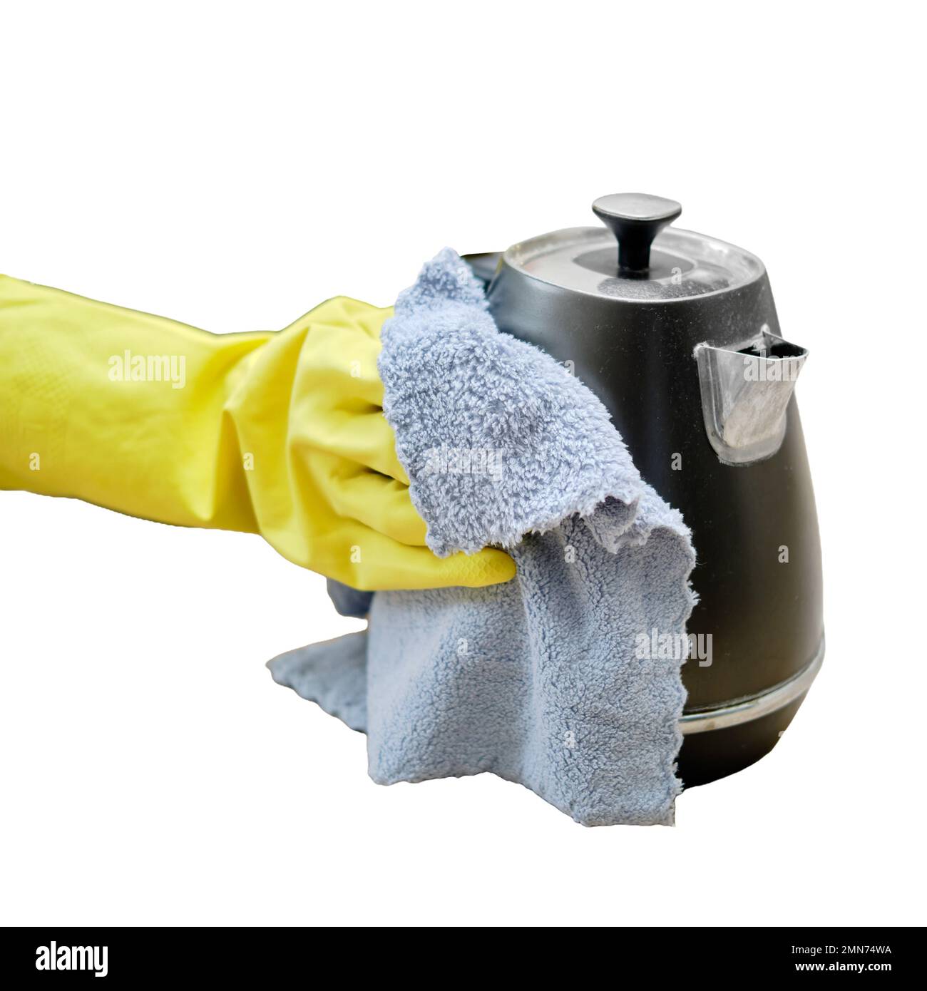 A woman wipes an electric kettle with a rag when cleaning a home ...