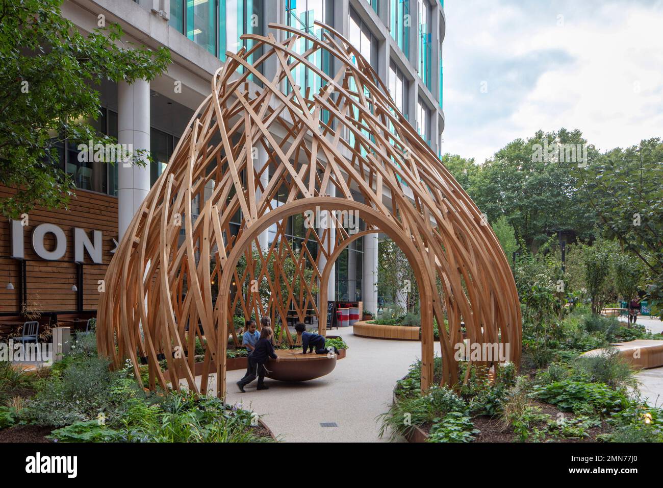 Adult and child sitting on the rotating bench. Osnaburgh Pavilion at ...