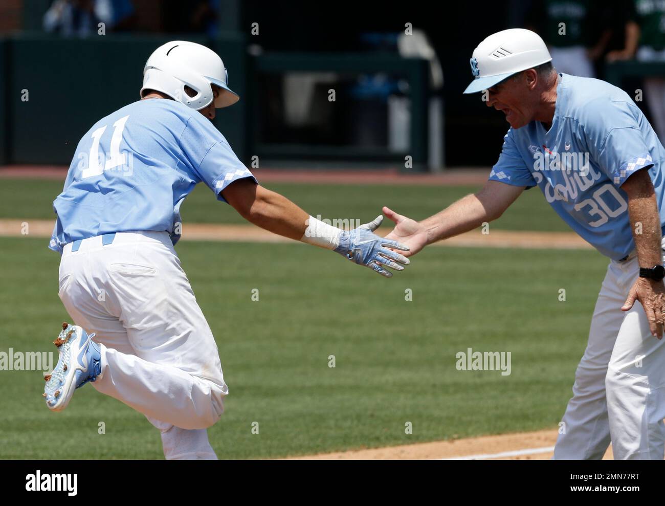 North Carolina's Cody Roberts (11) is congratulated by coach Mike Fox ...
