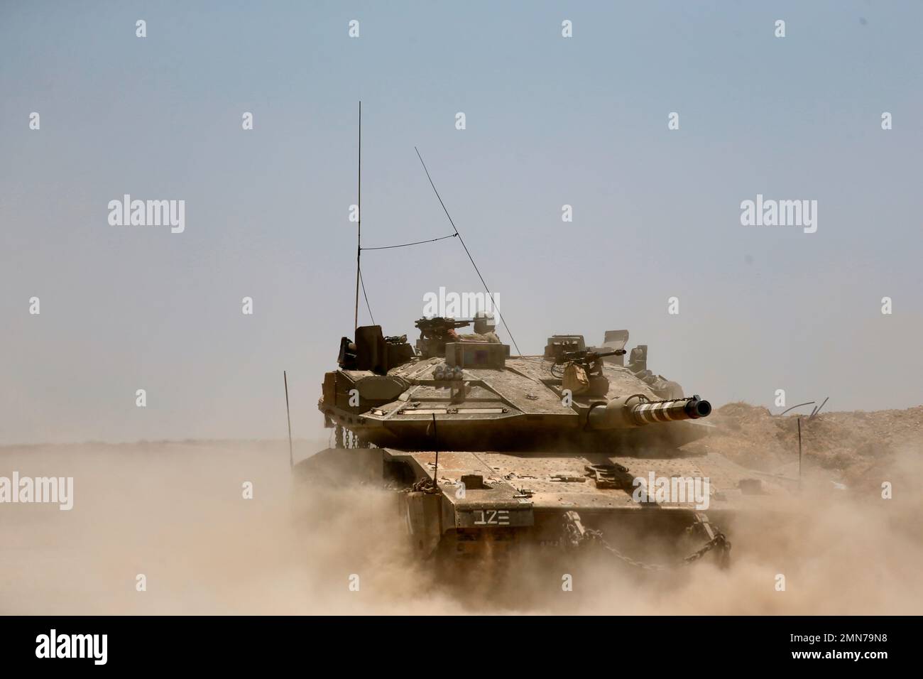 Israeli soldiers drive a tank to a position in the Israel Gaza border ...