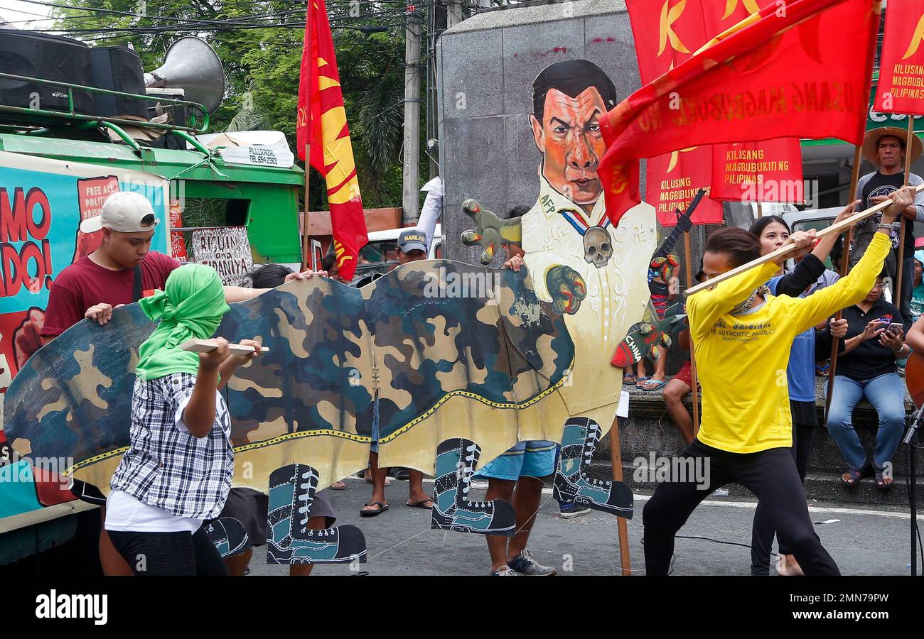 Protesters hit an effigy depicting President Rodrigo Duterte as an ...