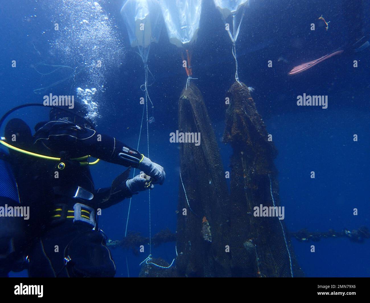In this Sunday, May 20, 2018, photo a group of divers recover an ...