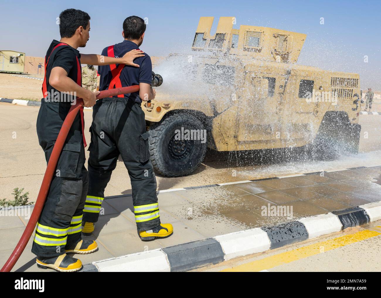 Royal Saudi Air Force firefighters decontaminate a U.S. Air Force ...