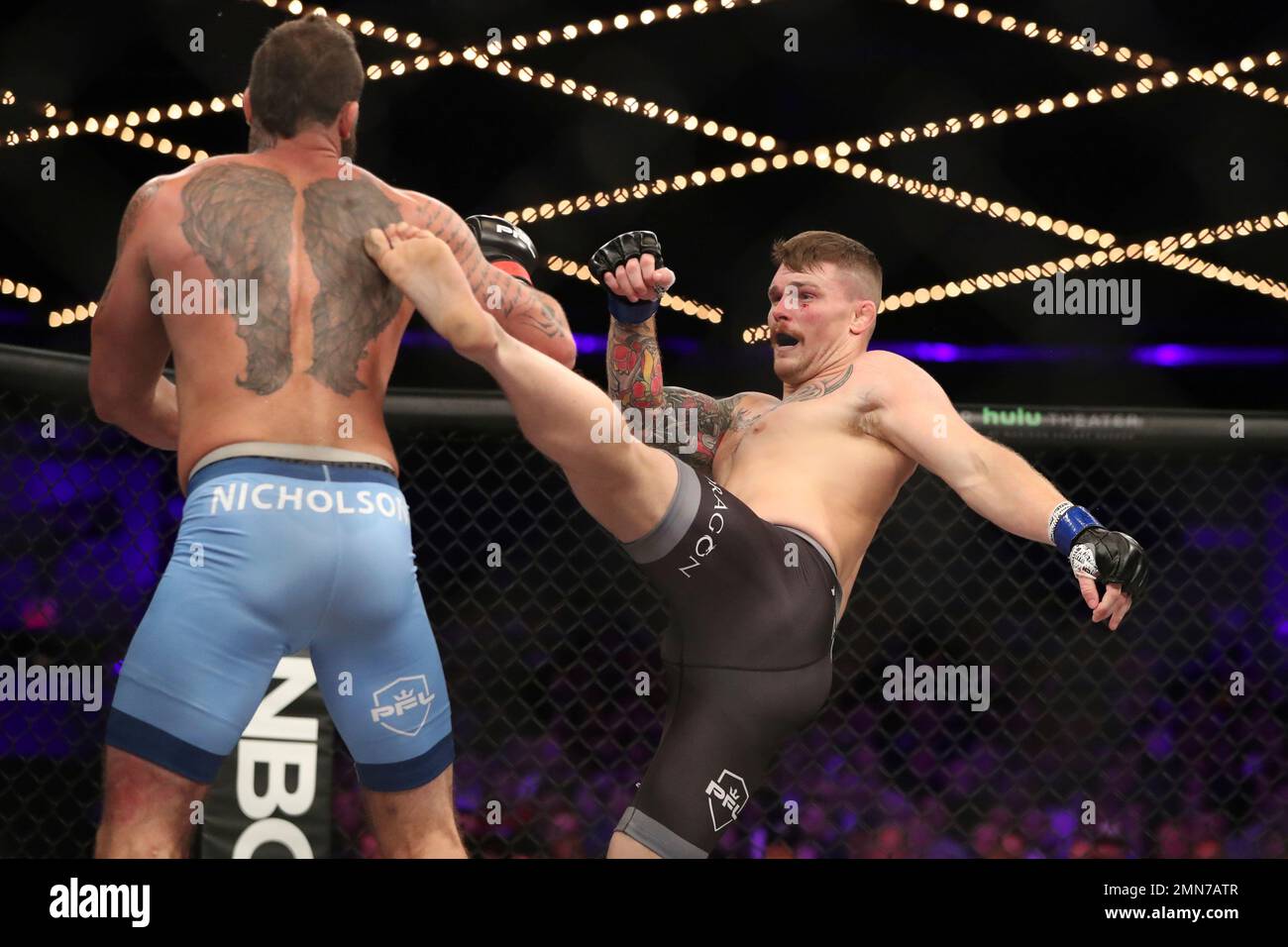 Alex Nicholson, left, absorbs a kick from Jake Heun during their mixed ...