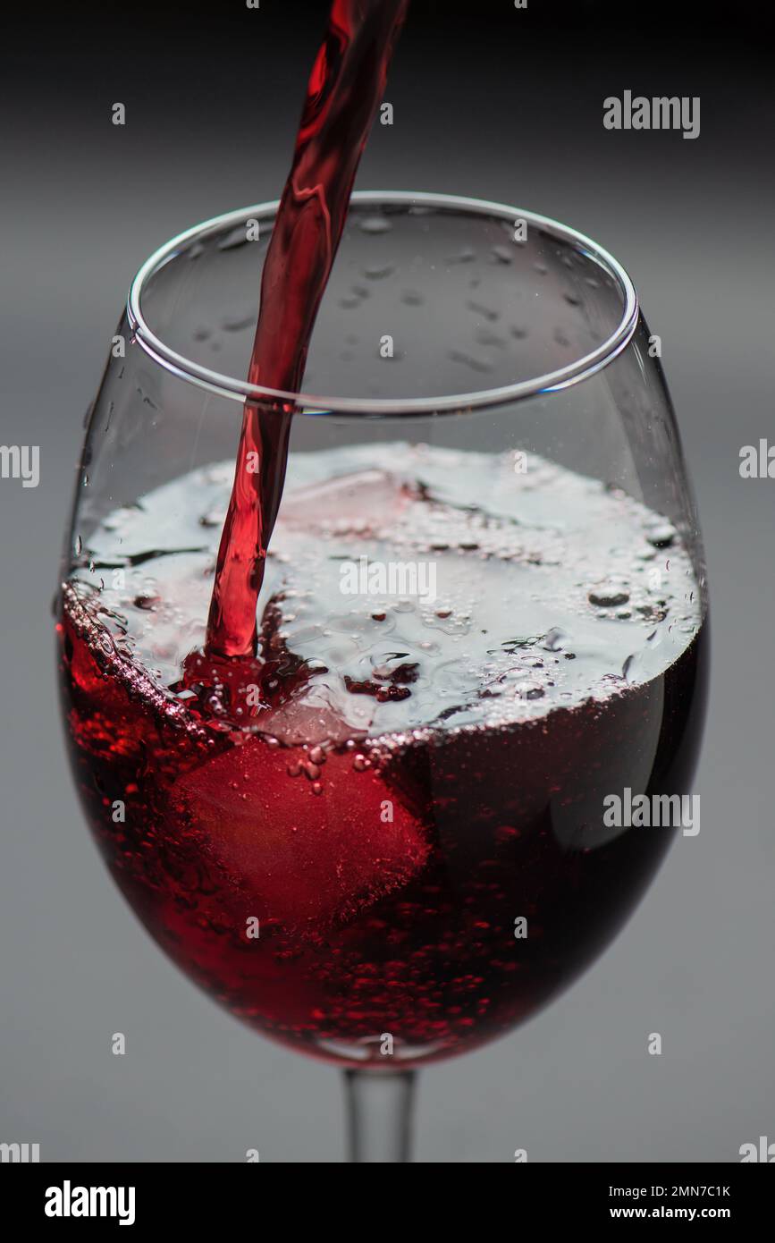 Pouring red wine into an ice glass with bubbles, high-quality studio shot, Close-up Stock Photo ...