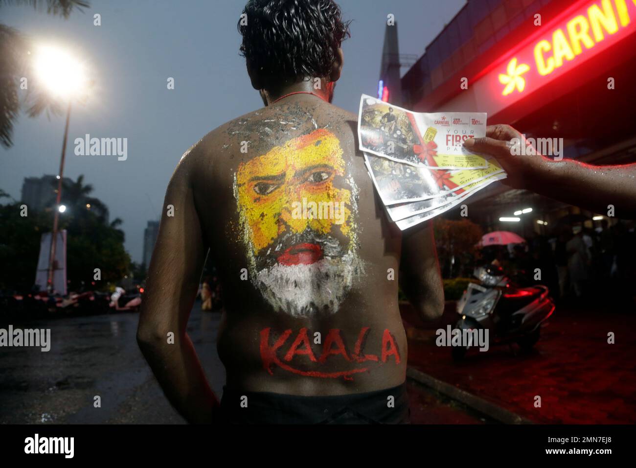 An Indian man with the face of Indian movie superstar Rajinikanth ...