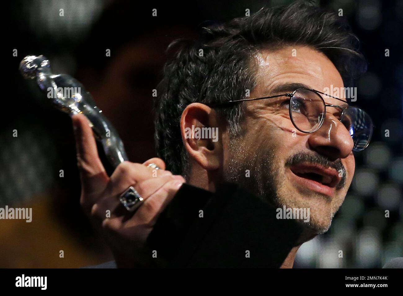 Mexican actor Miguel Rodarte holds up his trophy after he was named ...