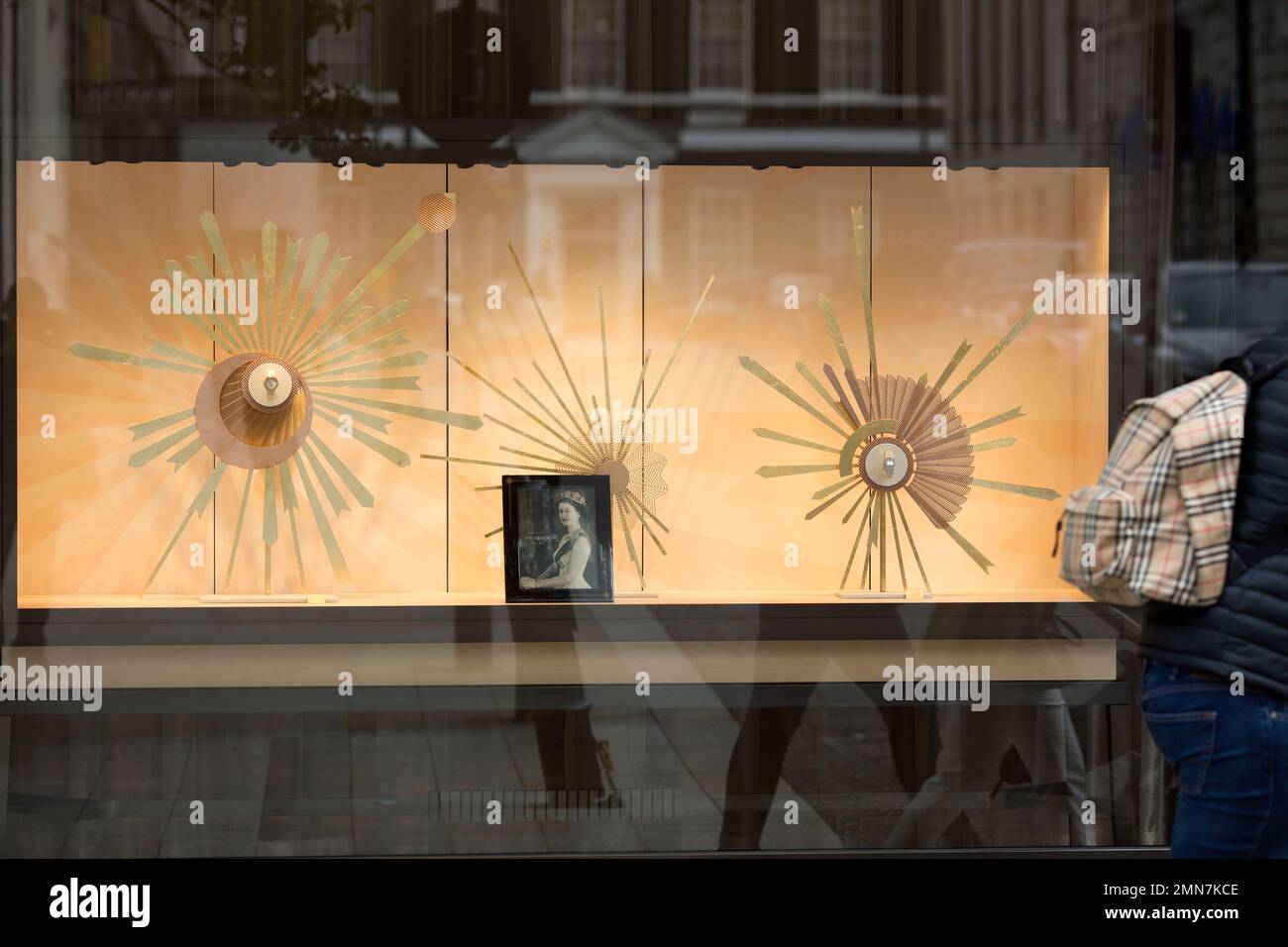 A portrait of Queen Elizabeth II is displayed in a shop window in ...