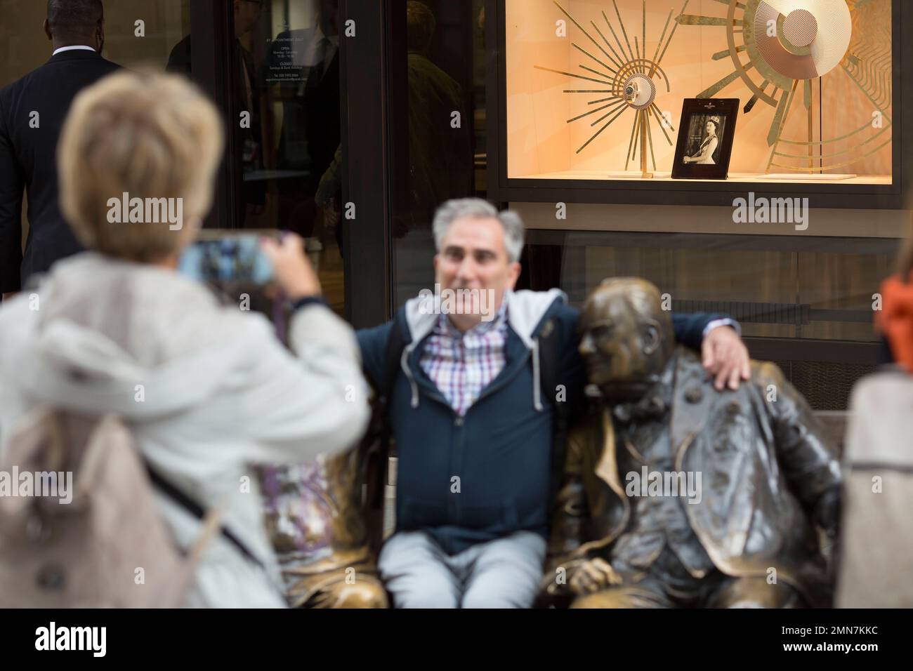 A portrait of Queen Elizabeth II is displayed in a shop window in ...